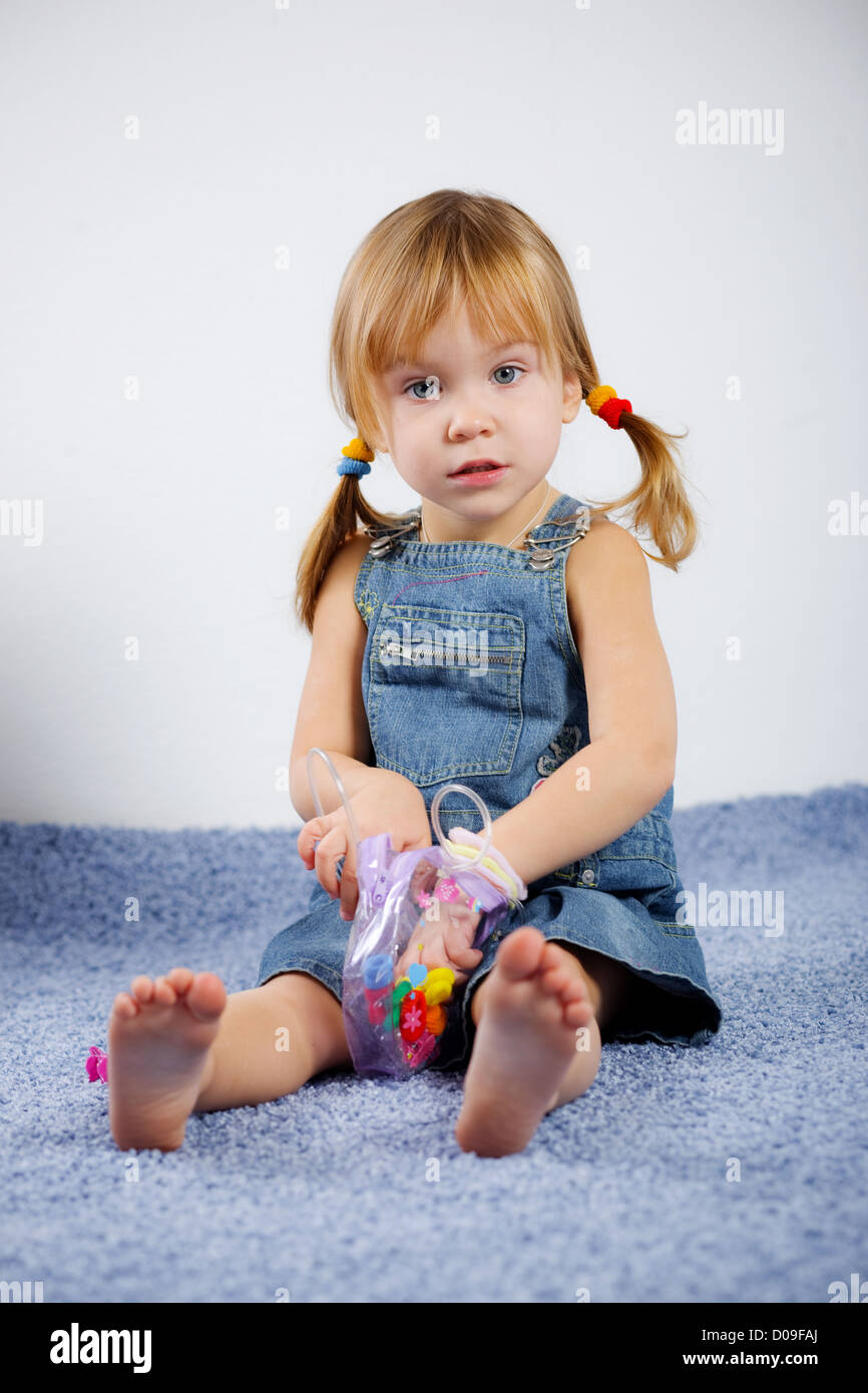 Cute child playing on carpet Stock Photo - Alamy