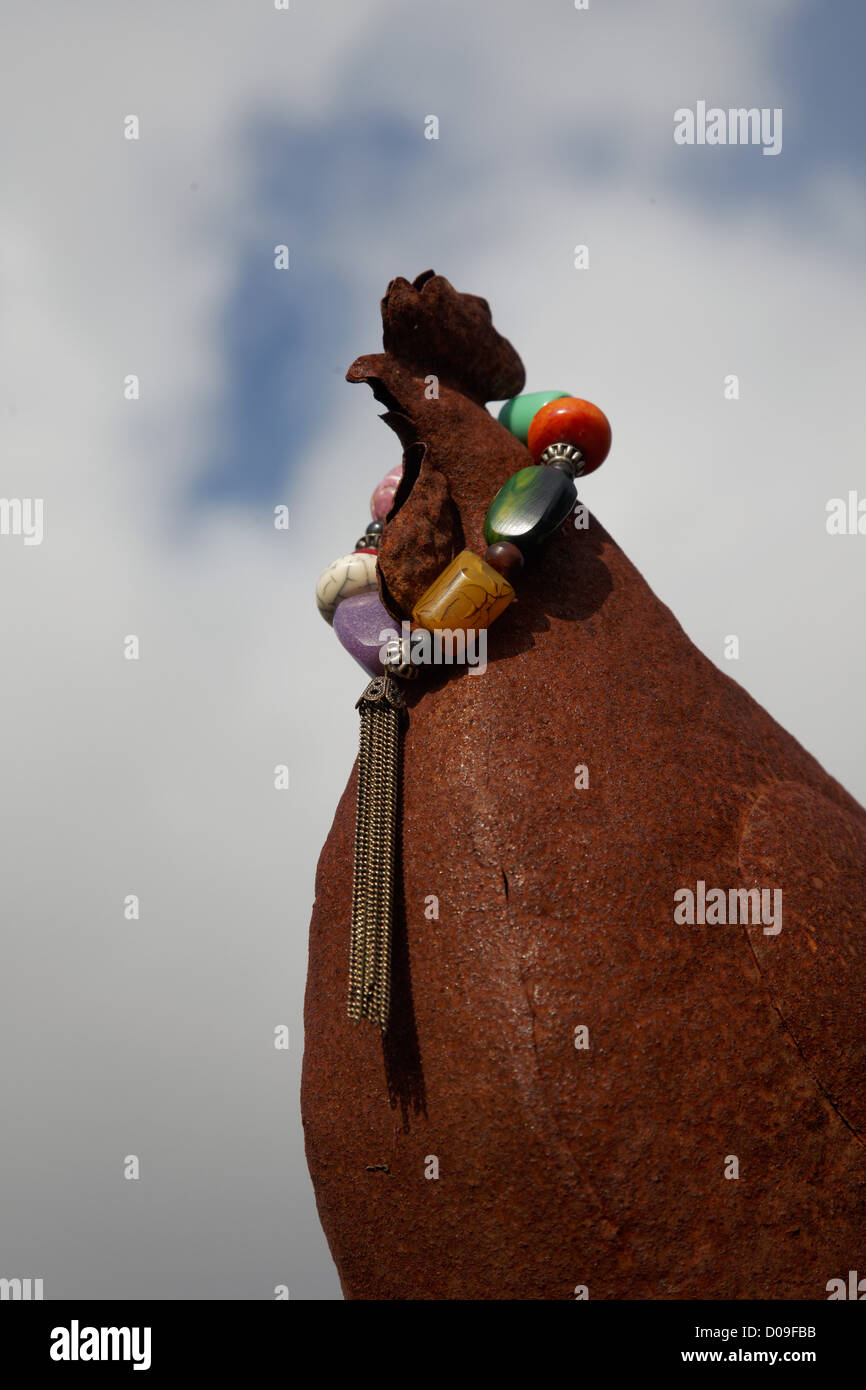 Rusty Chicken with Hand made jewellery on neck Stock Photo - Alamy