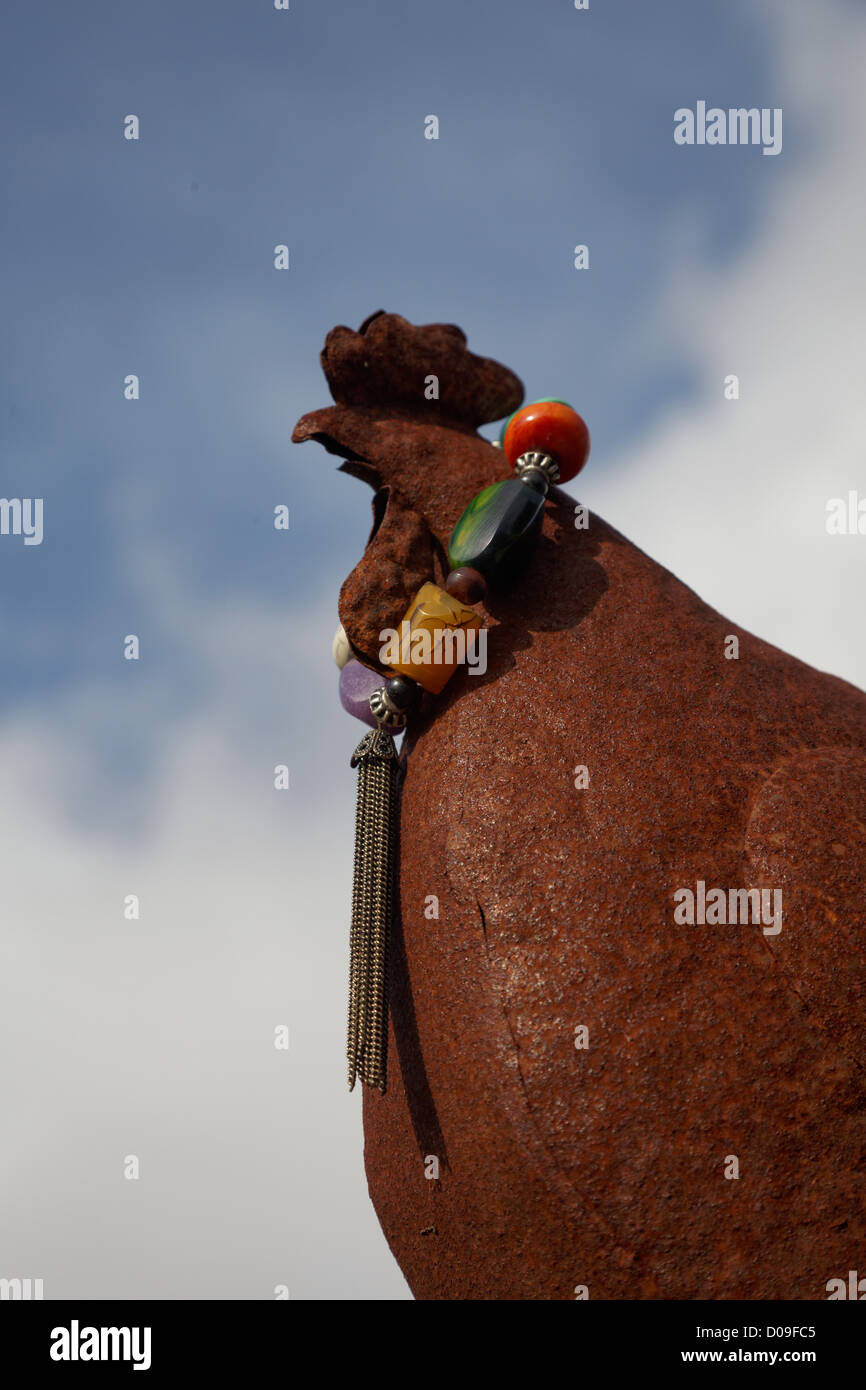 Rusty Chicken with Hand made jewellery on neck Stock Photo - Alamy