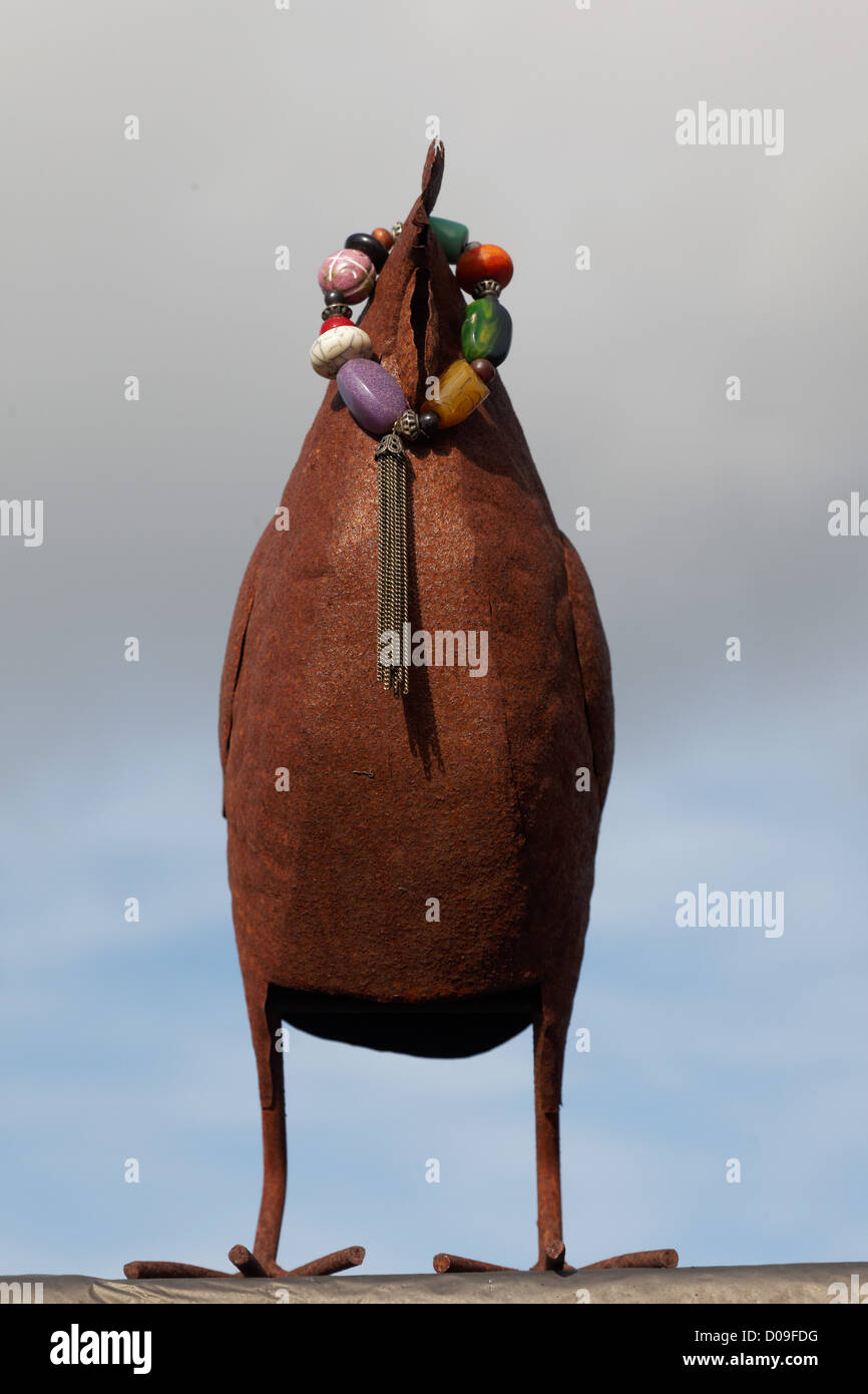 Rusty Chicken with Hand made jewellery on neck Stock Photo - Alamy