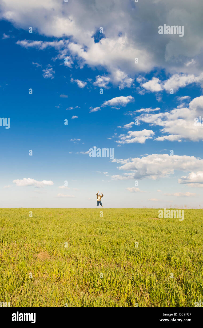 man one freedom green grass field infinite jumping happy Stock Photo ...