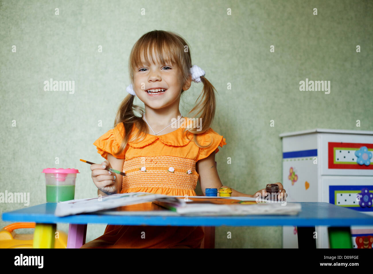 Cute girl draw diligently at home Stock Photo - Alamy