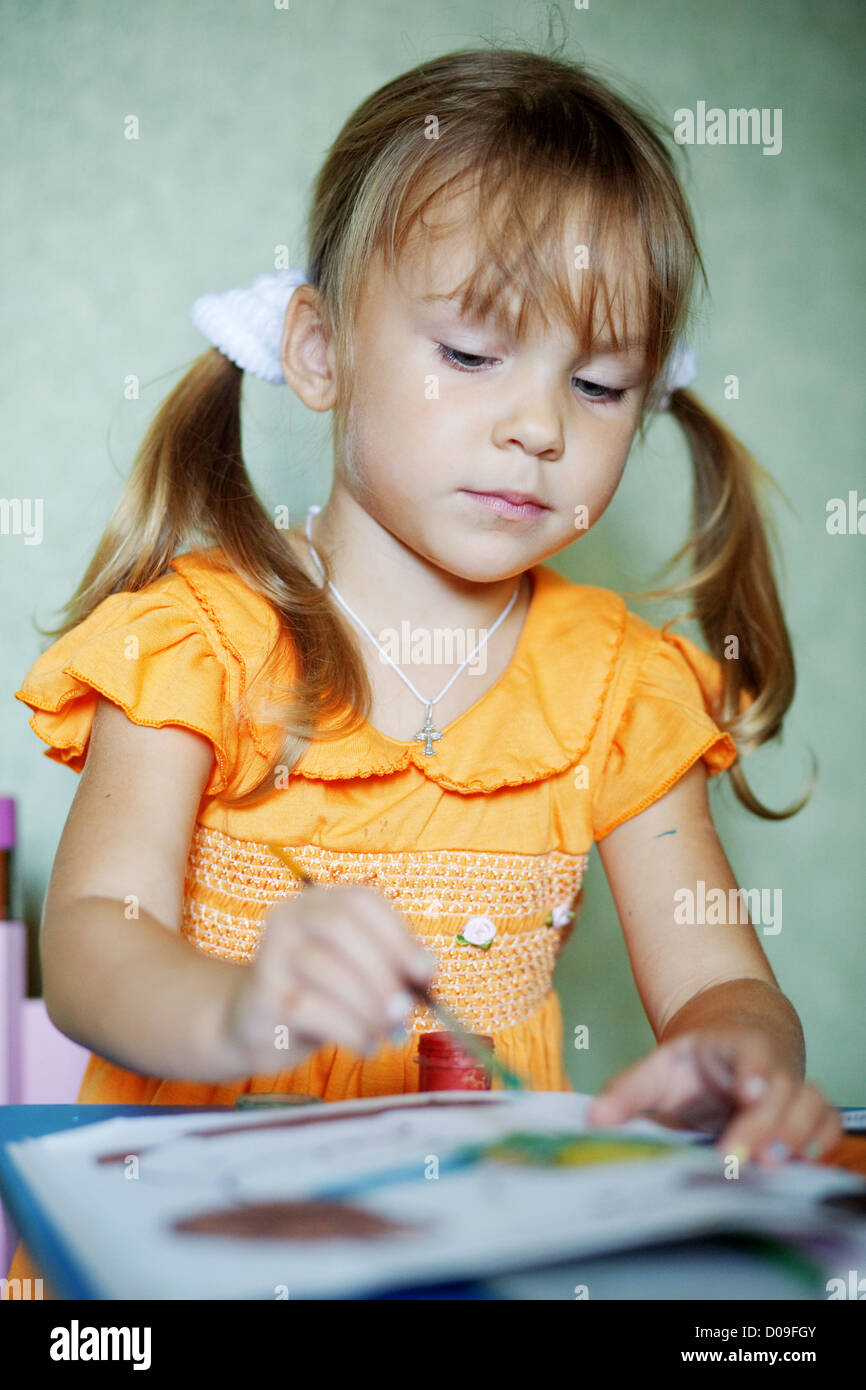 Cute girl draw diligently at home Stock Photo - Alamy