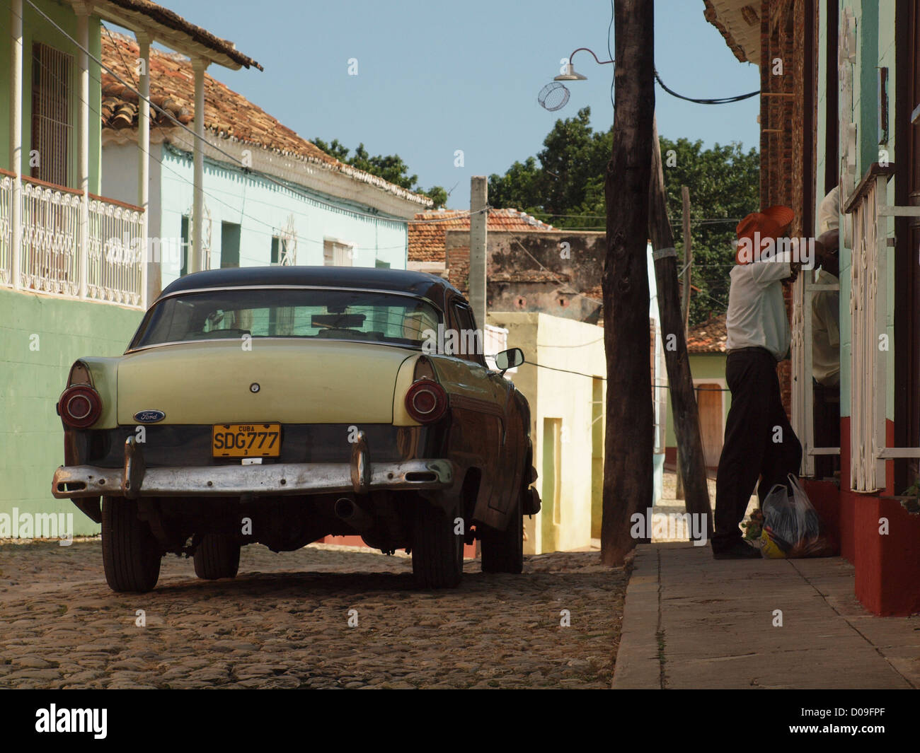 two-tone classic 1950s American car in Trinidad Cuba parked in typical ...