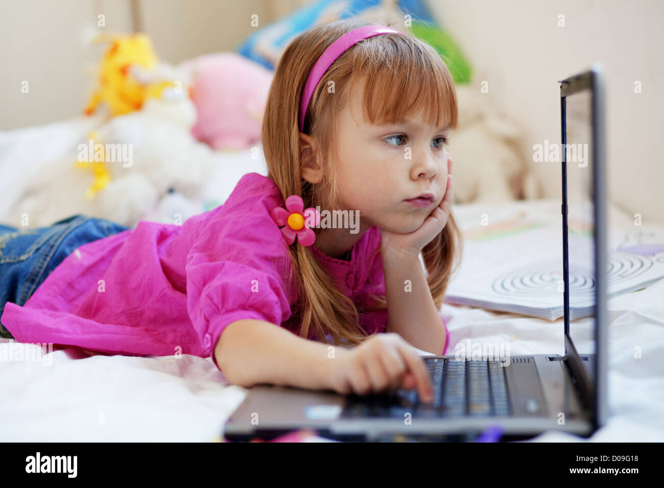 Little cute child playing with laptop at home Stock Photo - Alamy