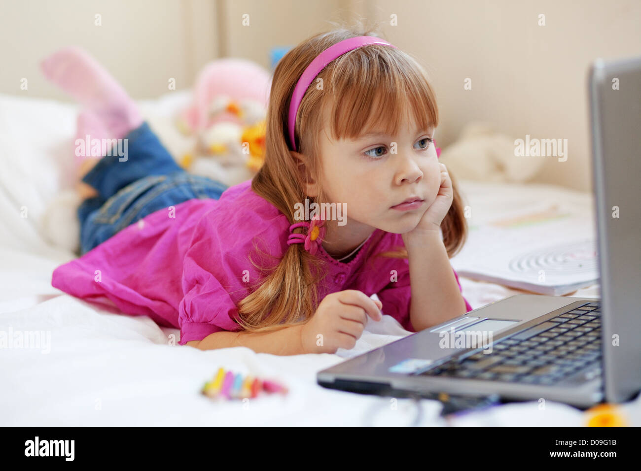 Little cute child playing with laptop at home Stock Photo - Alamy