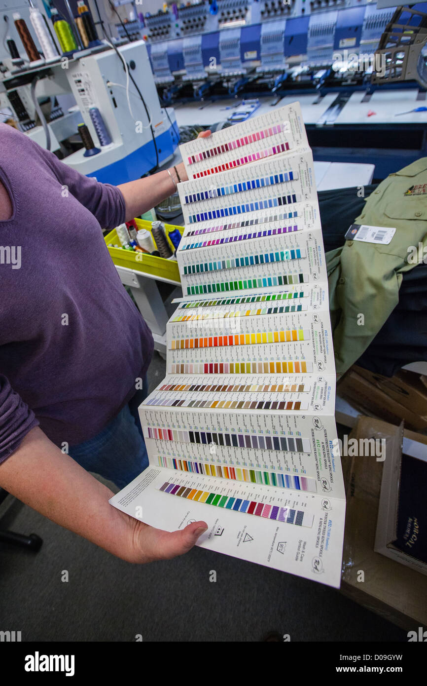 A person holds a color chart using Pantone colors for use with ...