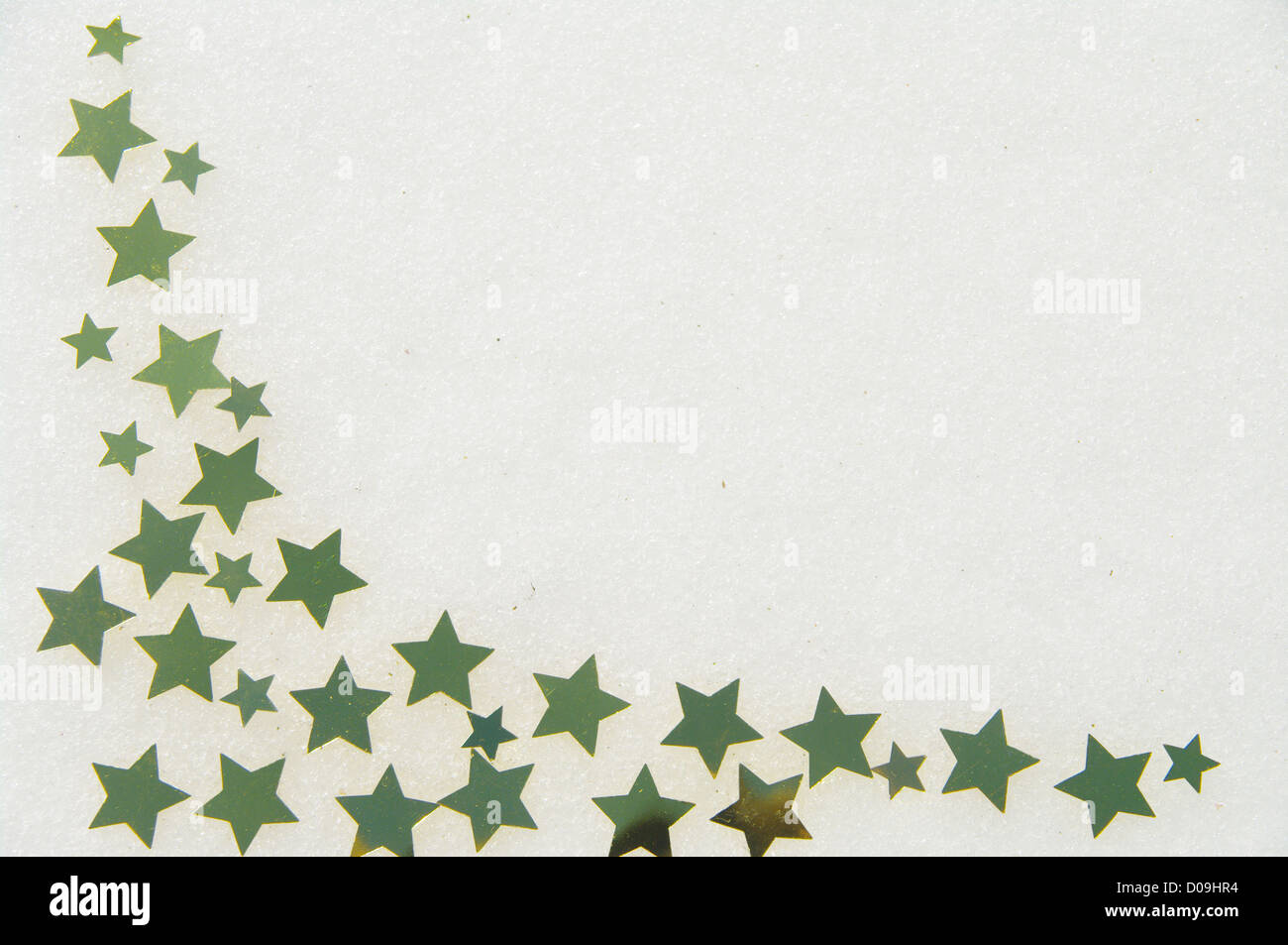 golden snow stars on a real snowy icy surface Stock Photo - Alamy