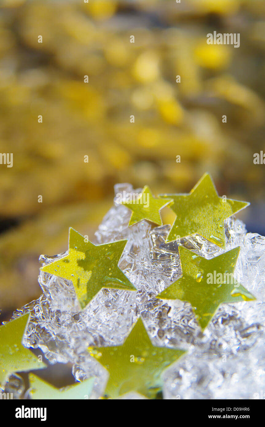 golden snow stars on a real snowy icy surface Stock Photo - Alamy