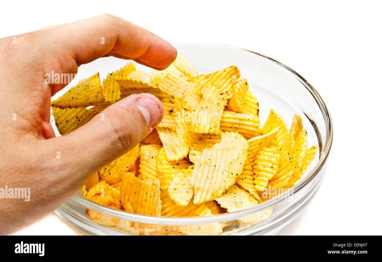 A hand is going to grab some chips Stock Photo - Alamy