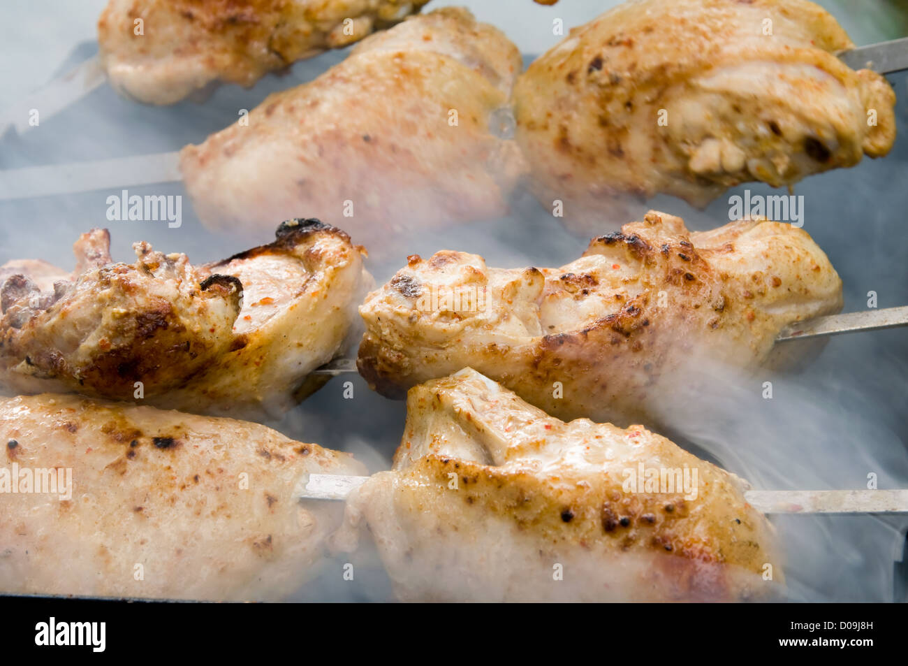 there is cooking outdoor a chicken grilled Stock Photo - Alamy