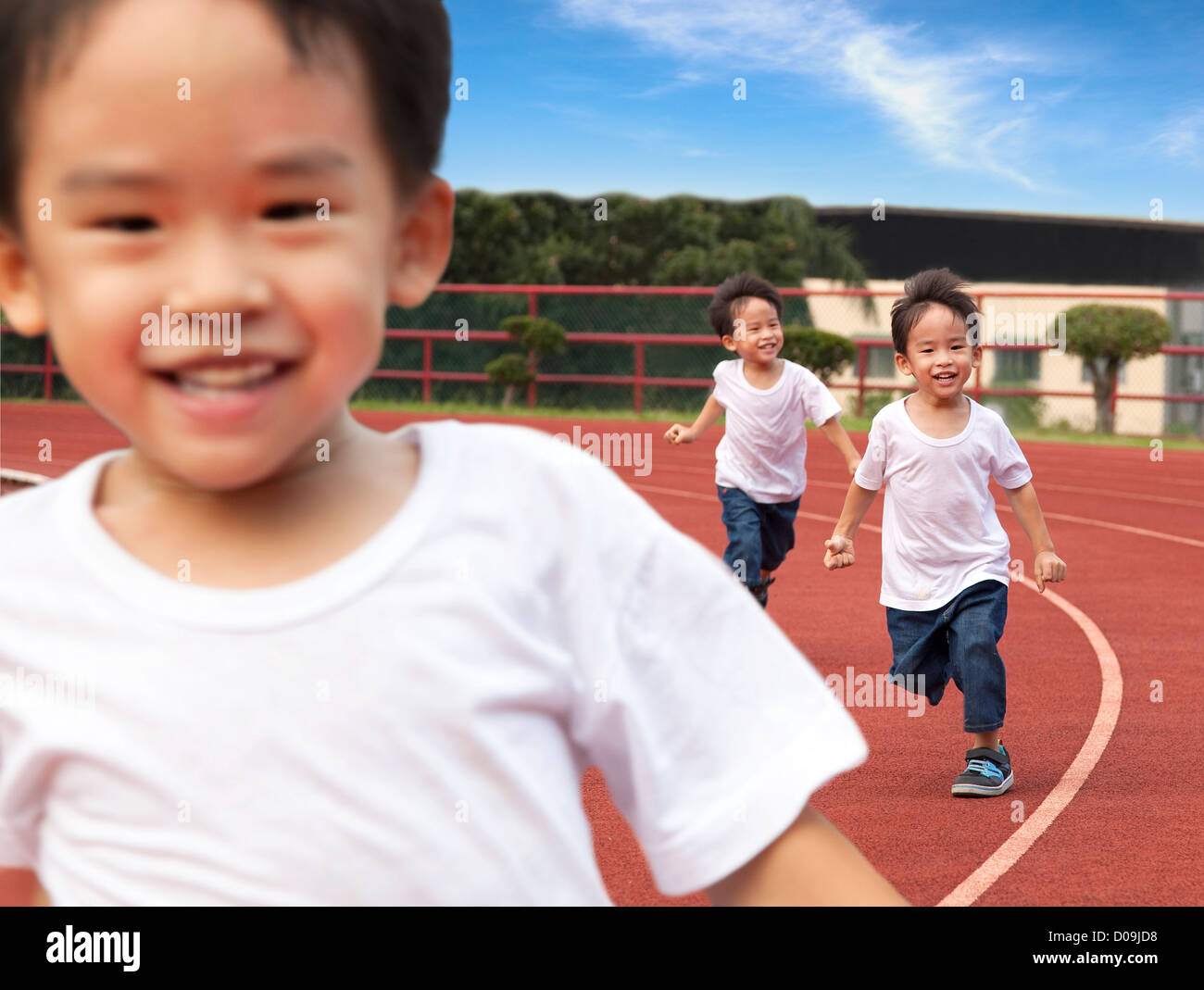 happy kids running on the Stadium track Stock Photo - Alamy