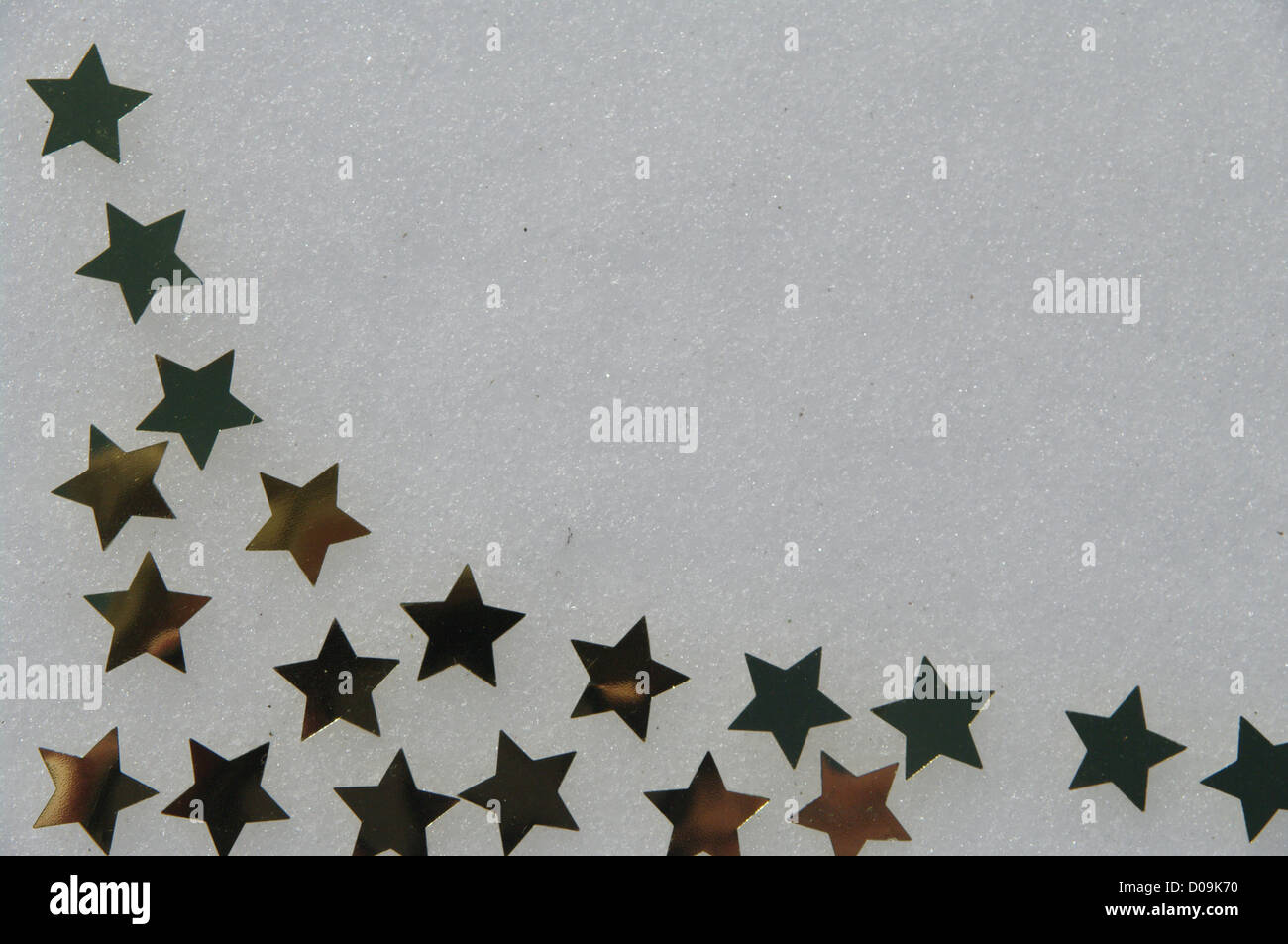 golden snow stars on a real snowy icy surface Stock Photo - Alamy