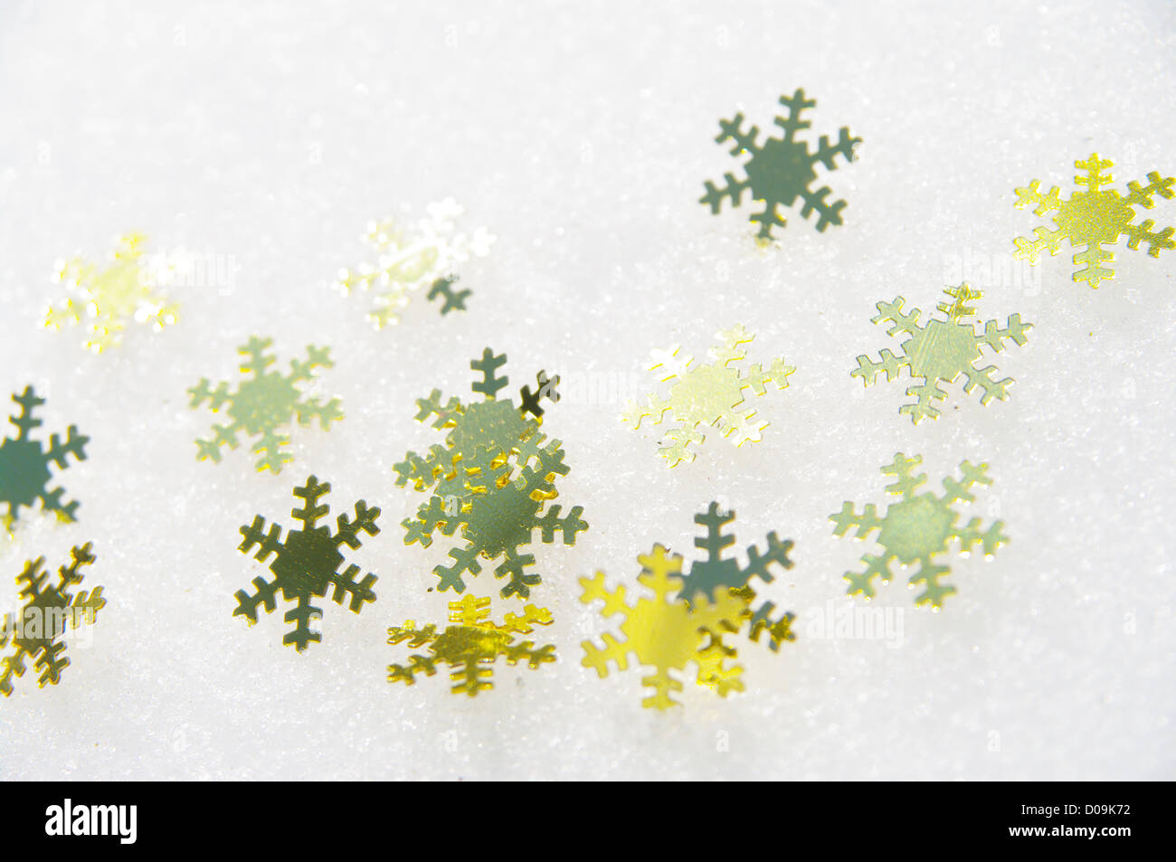 golden snow stars on a real snowy icy surface Stock Photo - Alamy