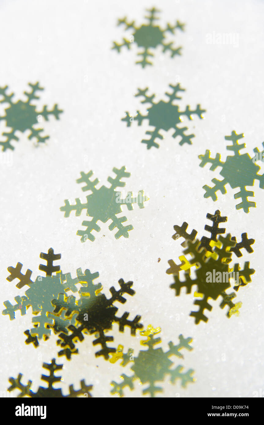 golden snow stars on a real snowy icy surface Stock Photo - Alamy