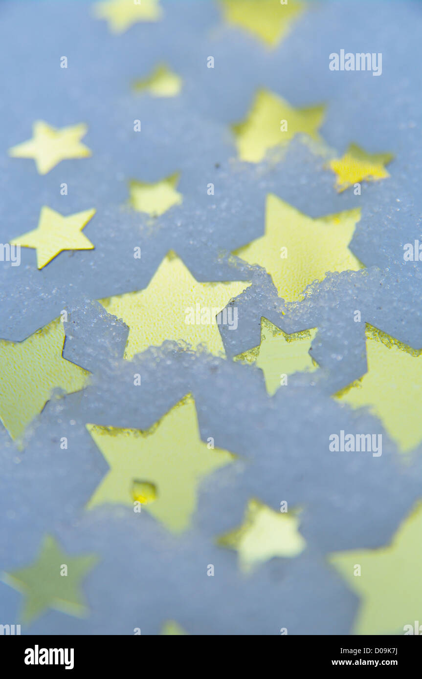 golden snow stars on a real snowy icy surface Stock Photo - Alamy