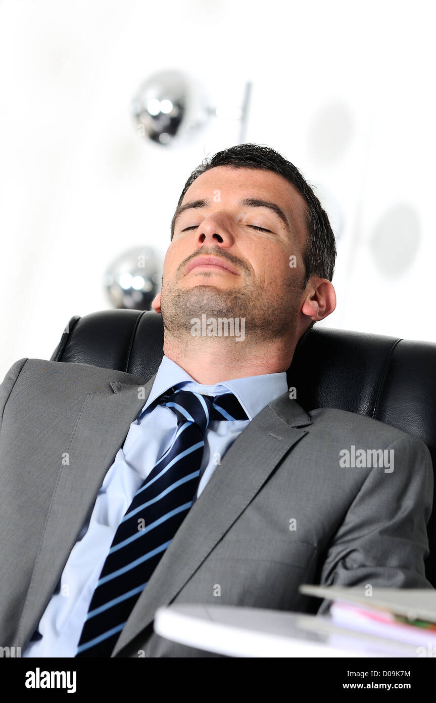 Attractive businessman is sleeping a while from business Stock Photo ...