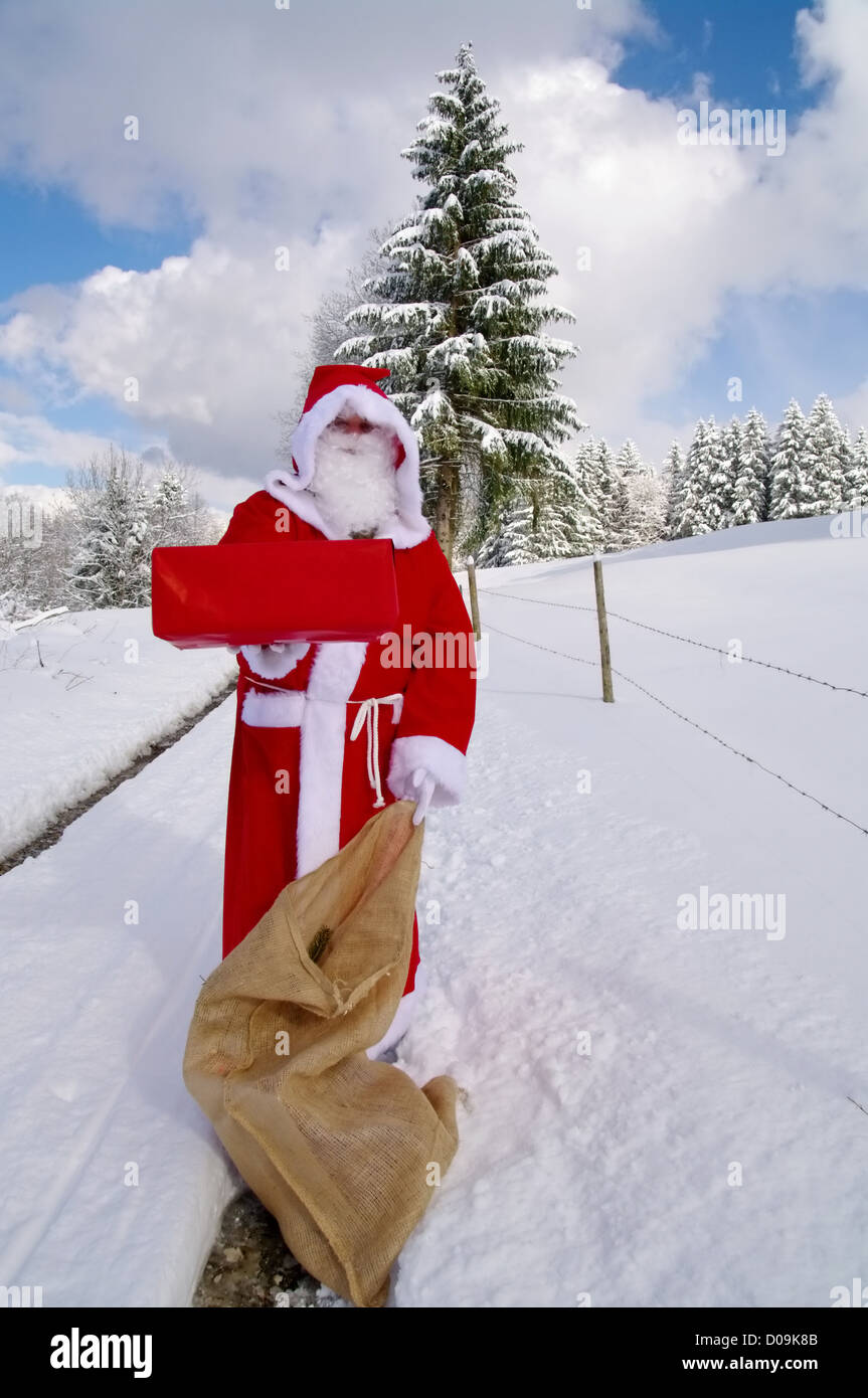 Santa Claus, Father Christmas holds red present Stock Photo - Alamy