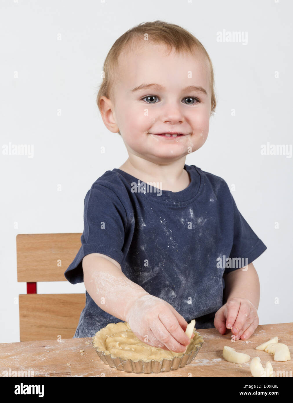 young child making cookies on small wooden desk Stock Photo - Alamy