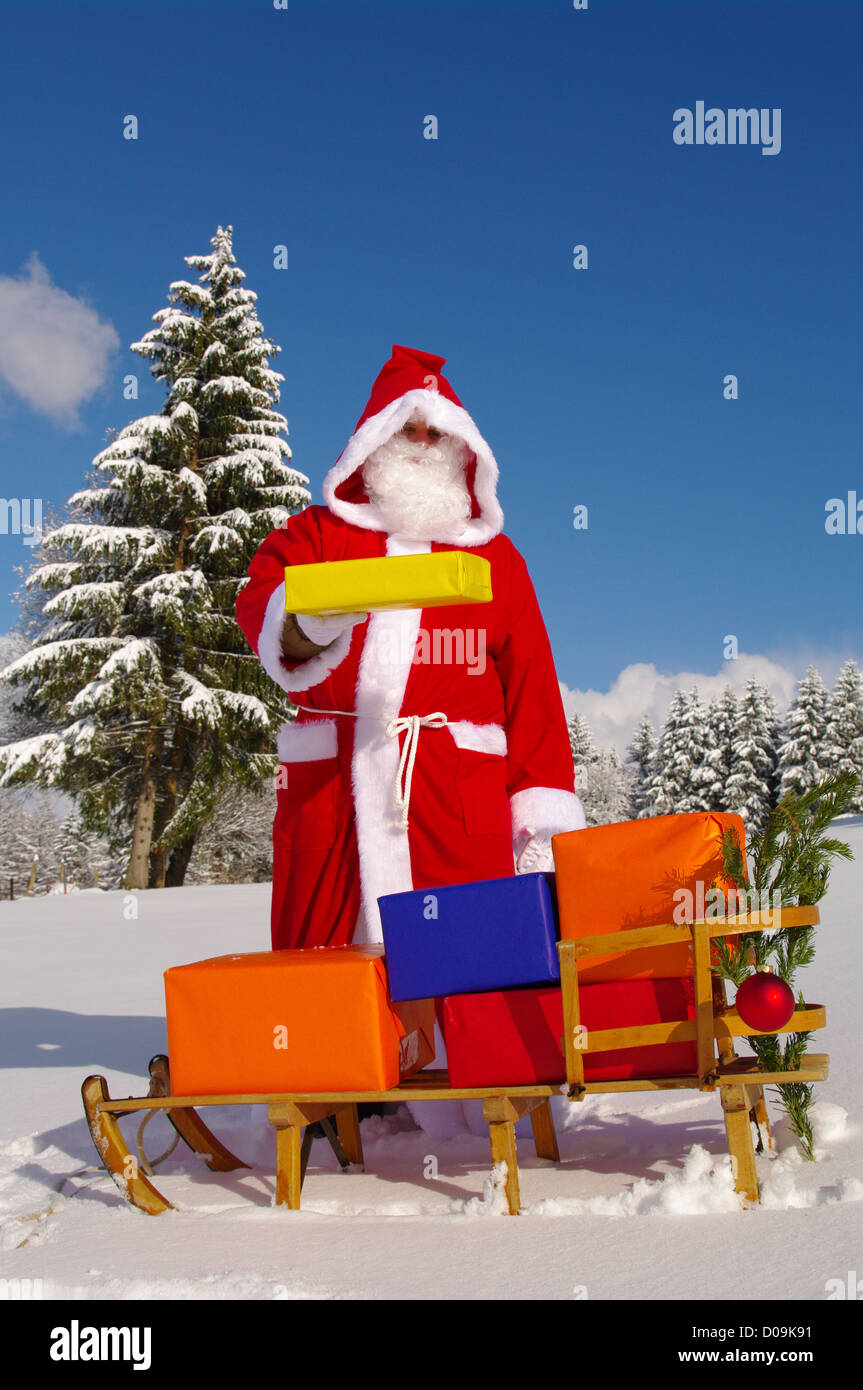 Santa Claus, Father Christmas with colorful presents on a sledge Stock ...