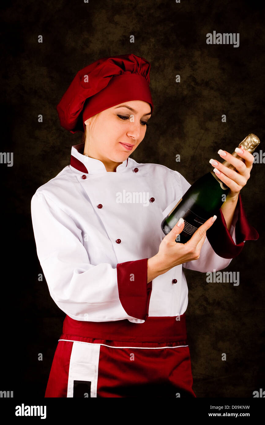 photo of young female chef with champagne bottle ready to open it Stock ...