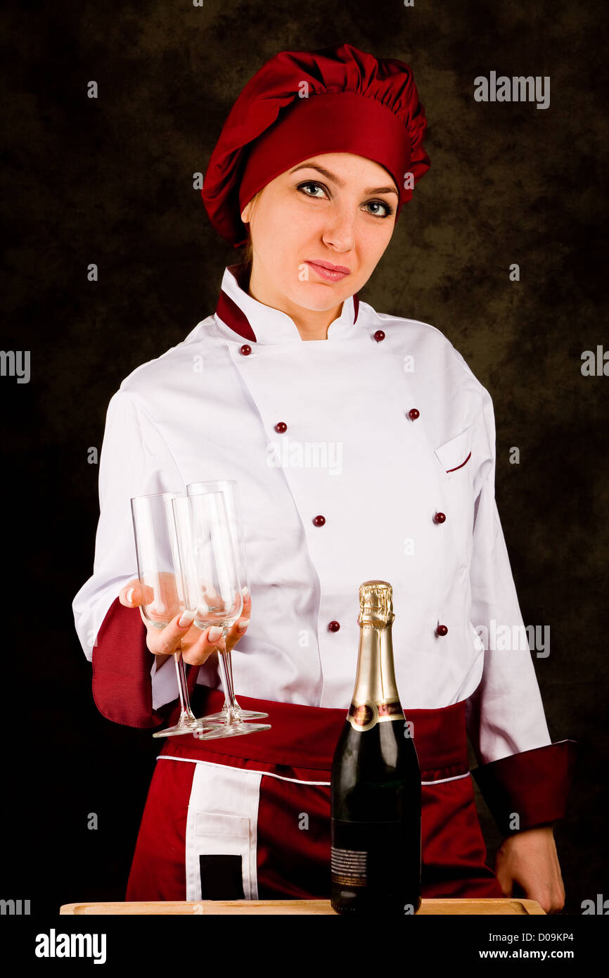 photo of young female chef with champagne bottle ready to open it Stock ...