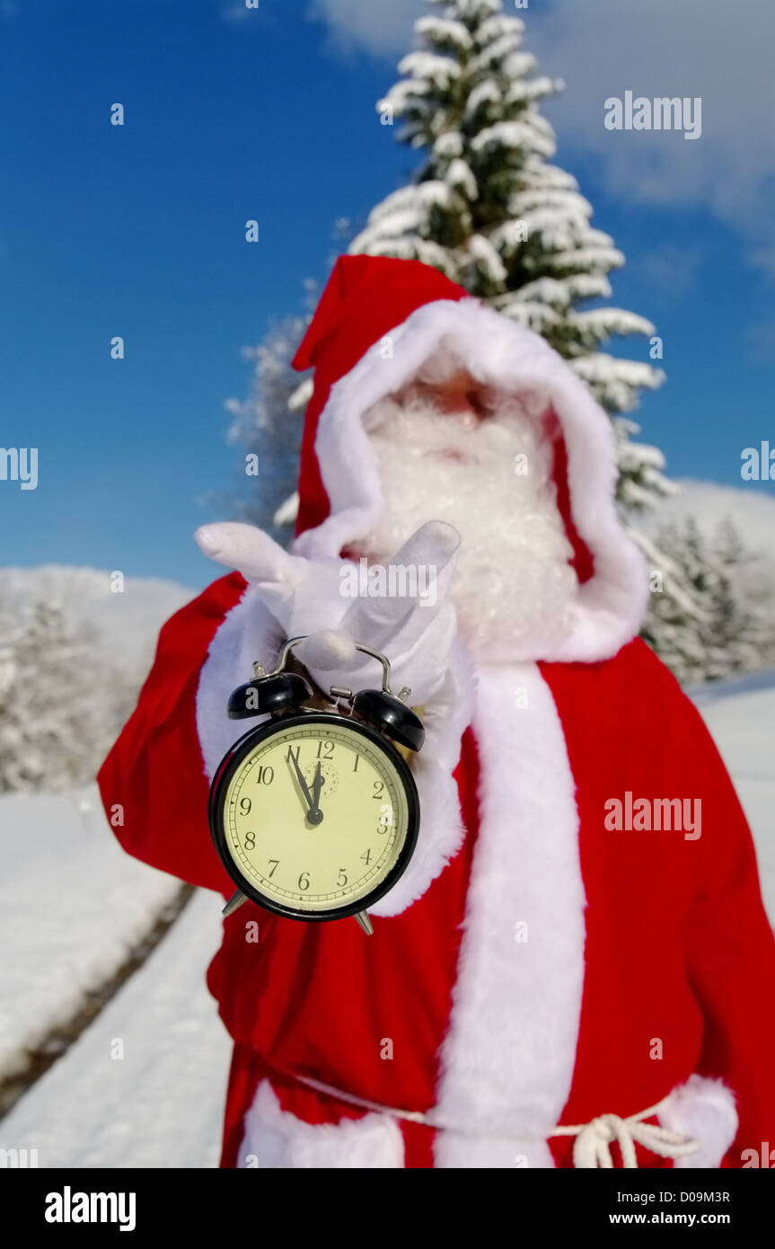 Santa Claus, Father Christmas holds watch clock Stock Photo - Alamy