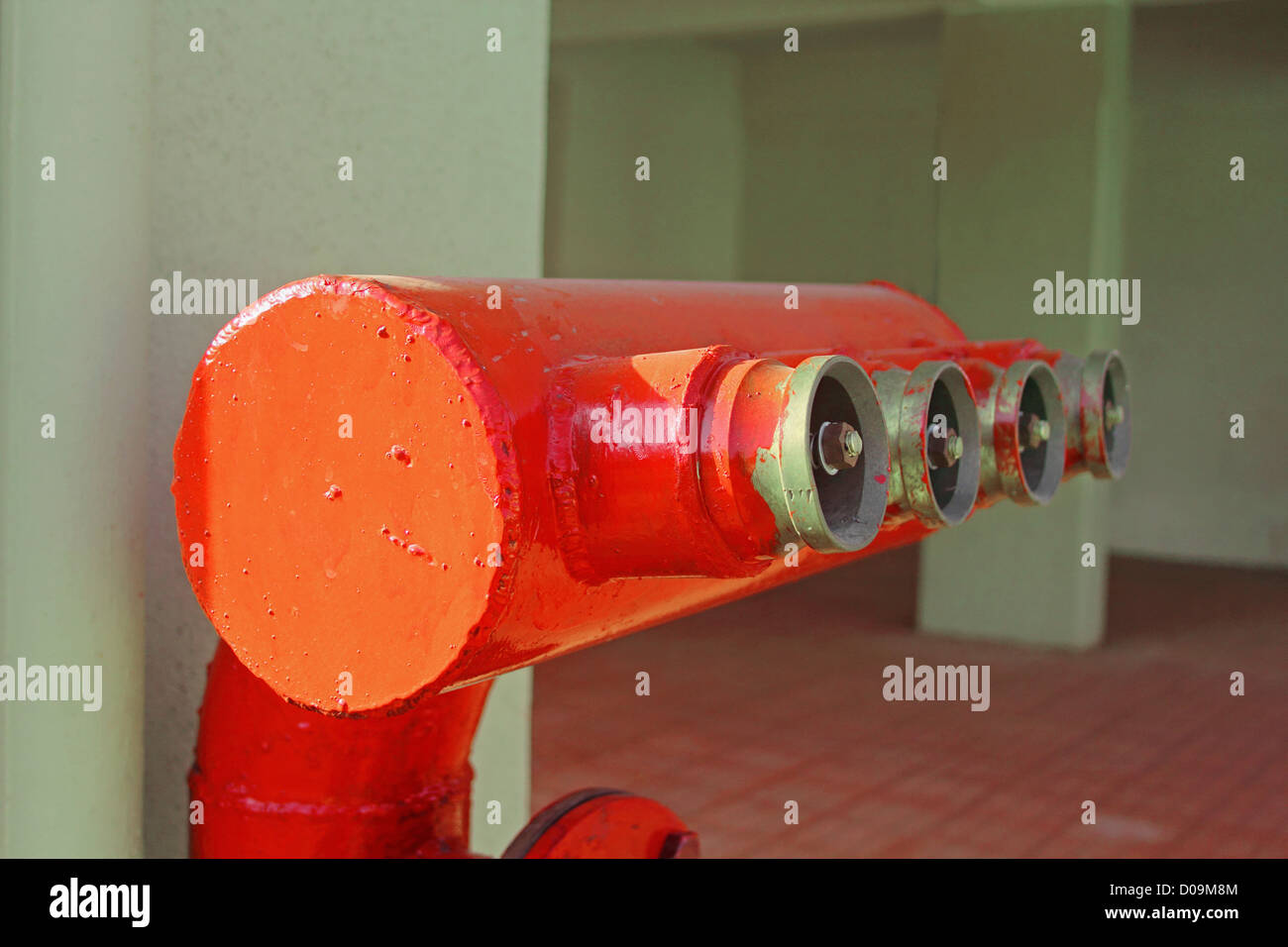 Red fire water lines in front of a building Stock Photo - Alamy