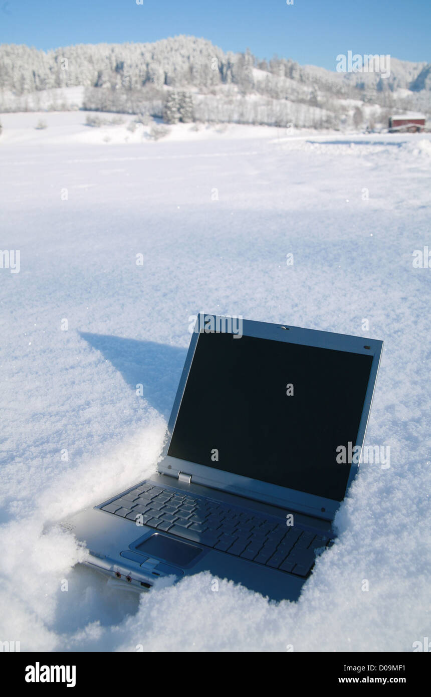 Laptop in a snowy winter landscape scene Stock Photo - Alamy