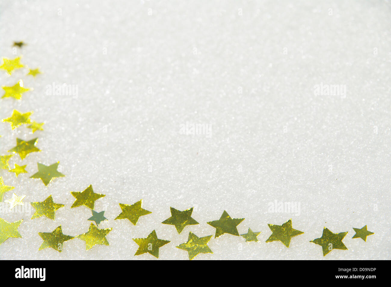 golden snow stars on a real snowy icy surface Stock Photo - Alamy