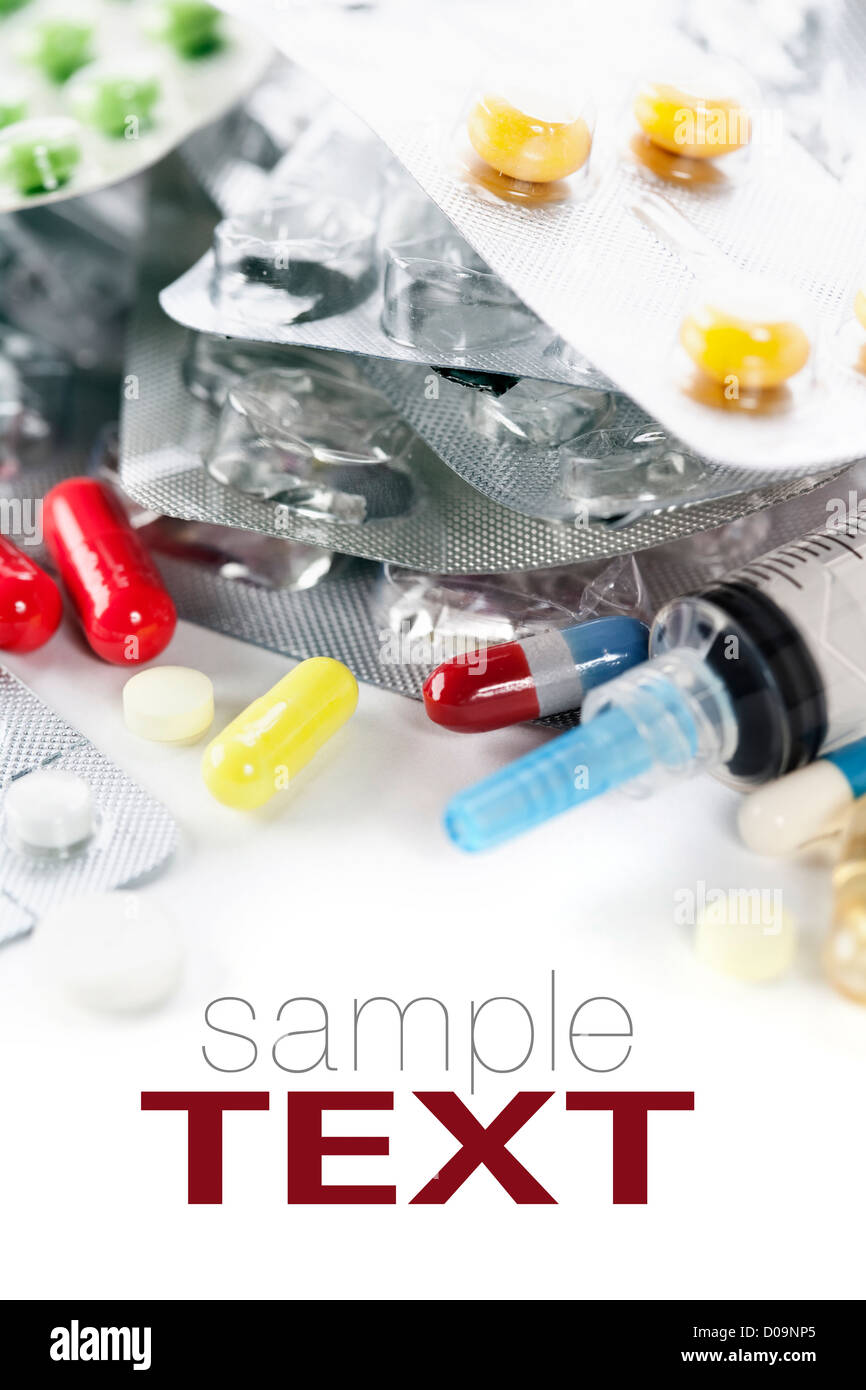 Packs of different pills and Syringe with copyspace(with sample text ...