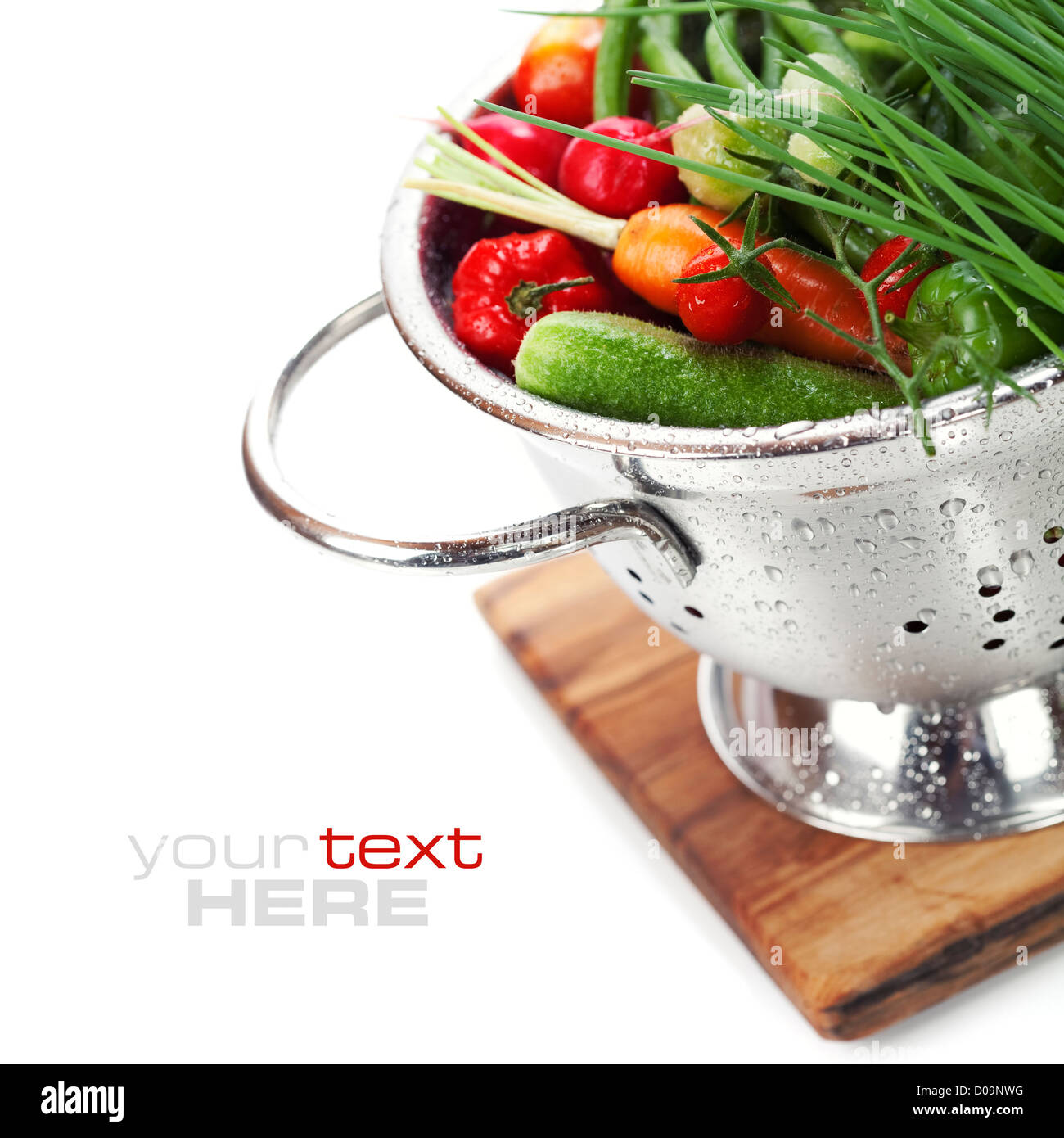 Fresh vegetables in metal colander over white (with sample text Stock ...