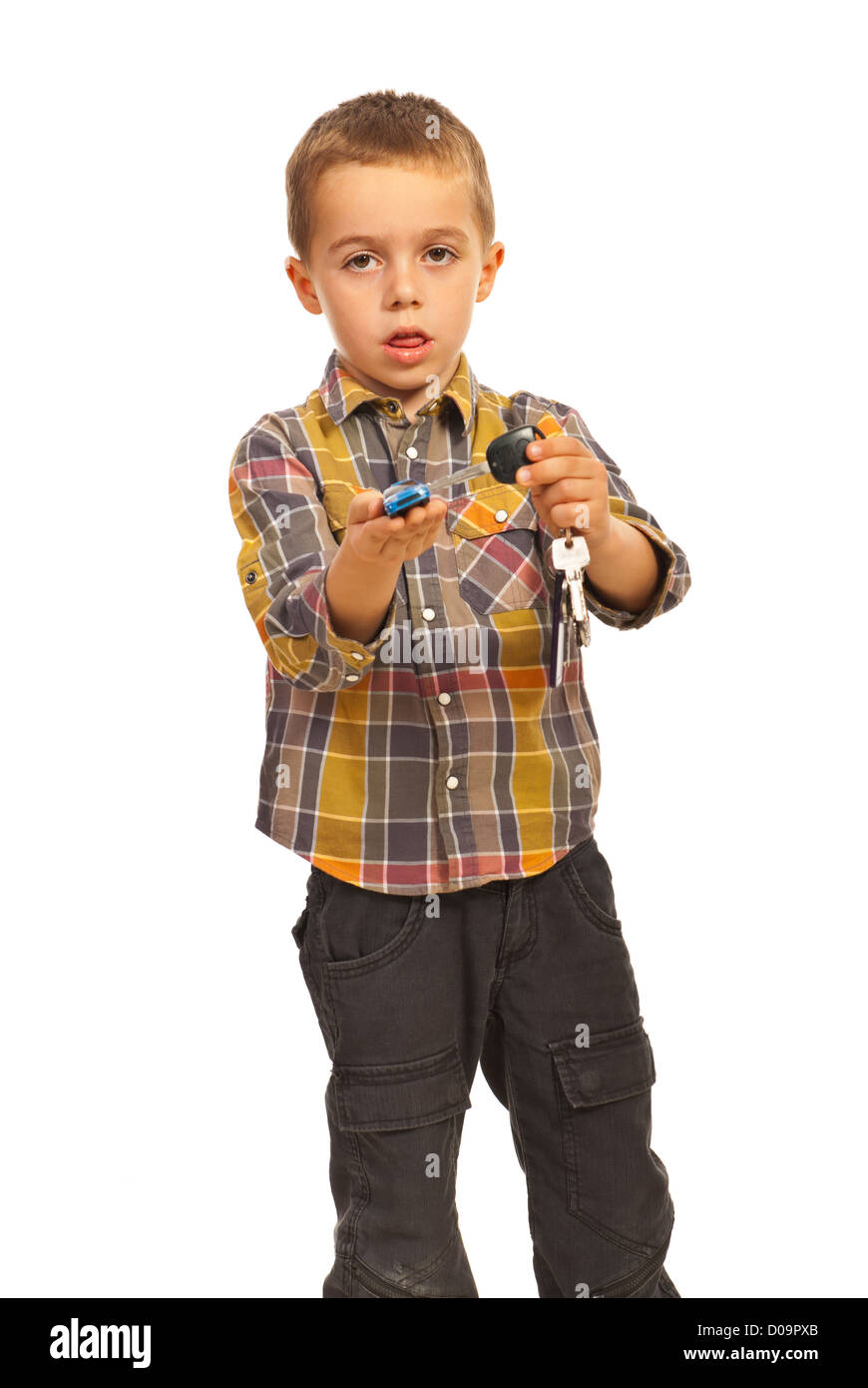 Kid boy showing car and keys opening toy isolated on white background ...