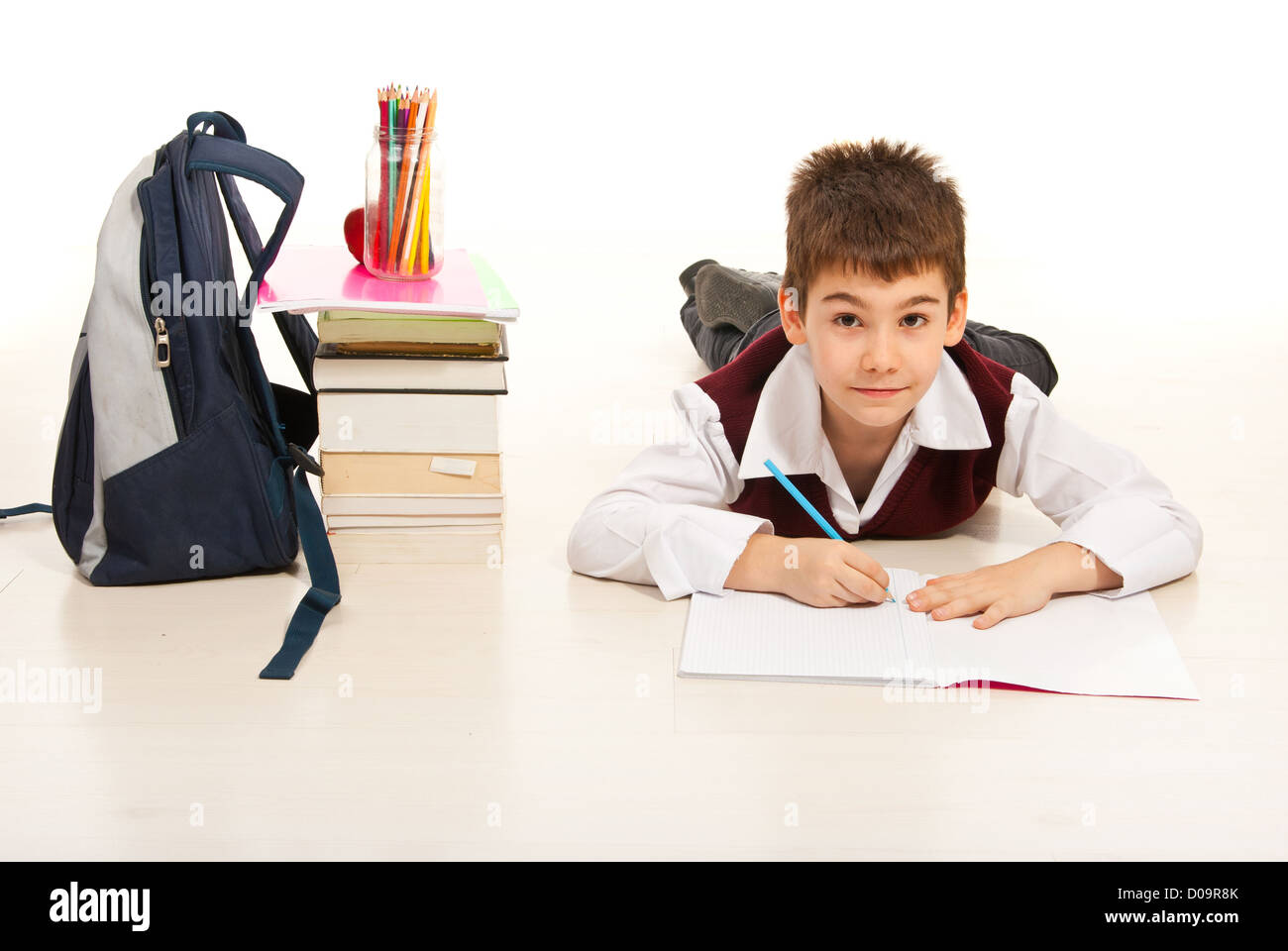 Student boy lying on the floor home and doing homework Stock Photo - Alamy