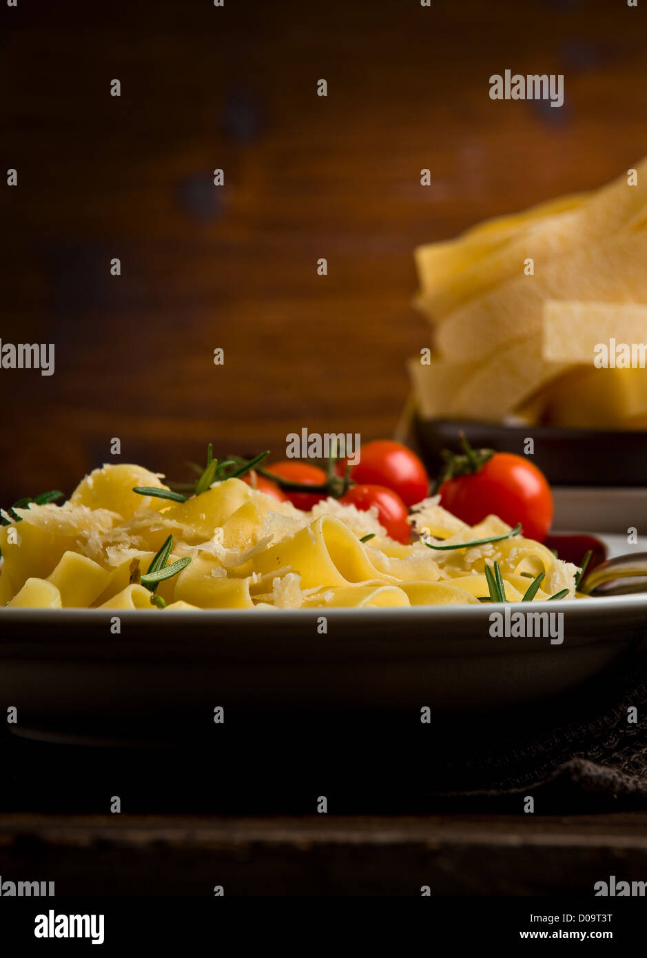 photo of deliciuos pasta with rosemary on rustic wooden table Stock ...