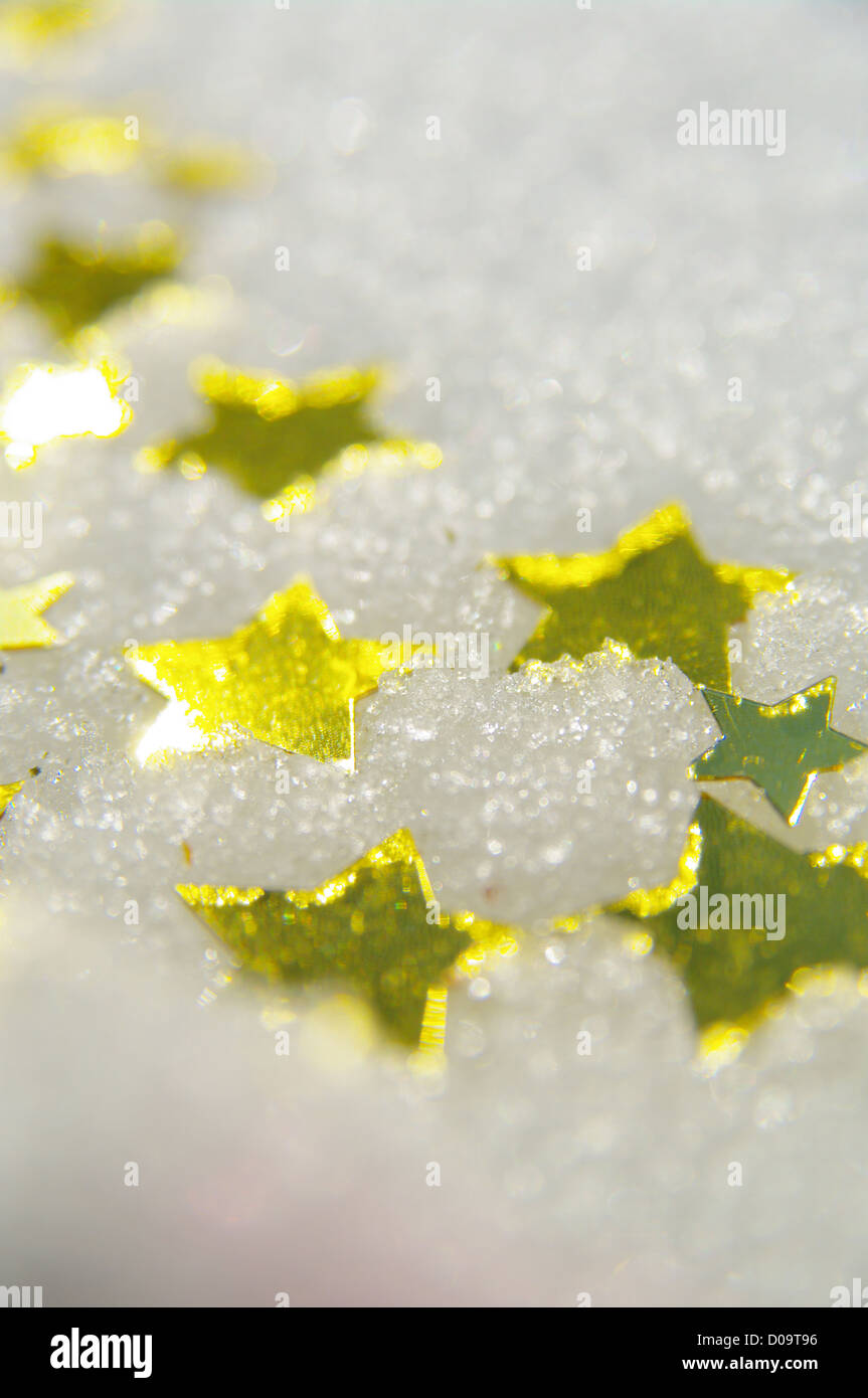 golden snow stars on a real snowy icy surface Stock Photo - Alamy