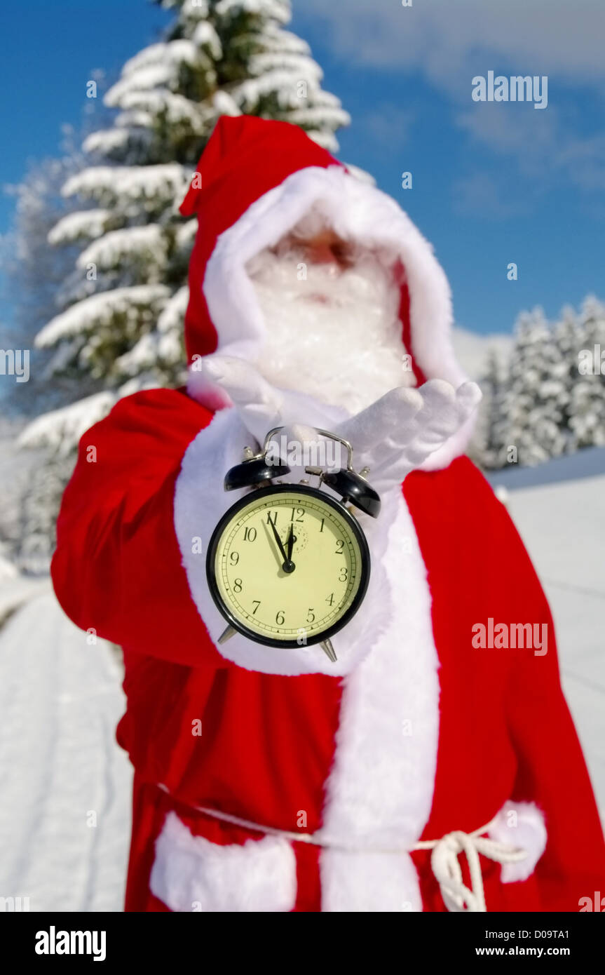 Santa Claus, Father Christmas holds watch clock Stock Photo - Alamy