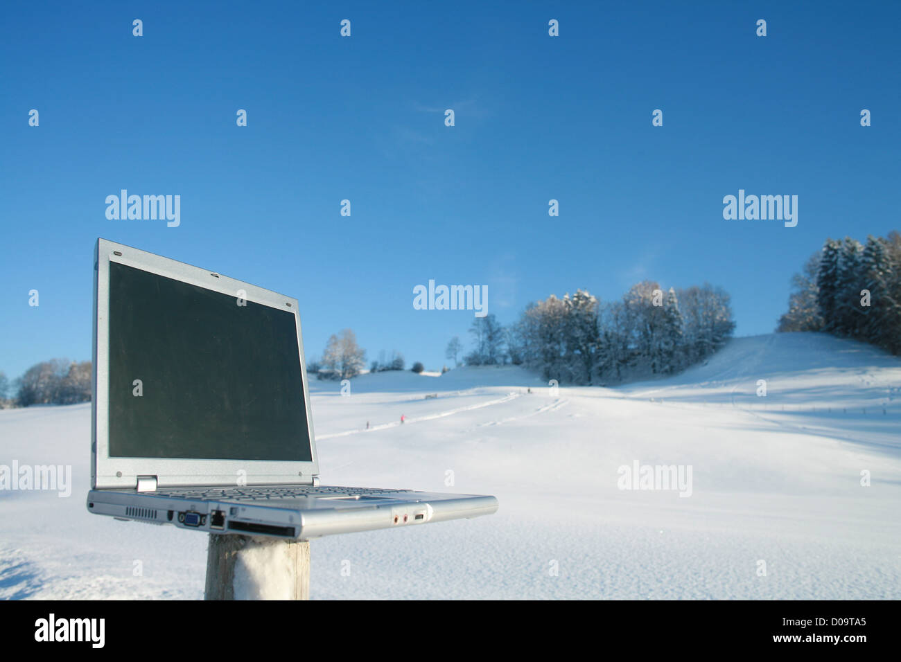 Laptop in a snowy winter landscape scene Stock Photo - Alamy