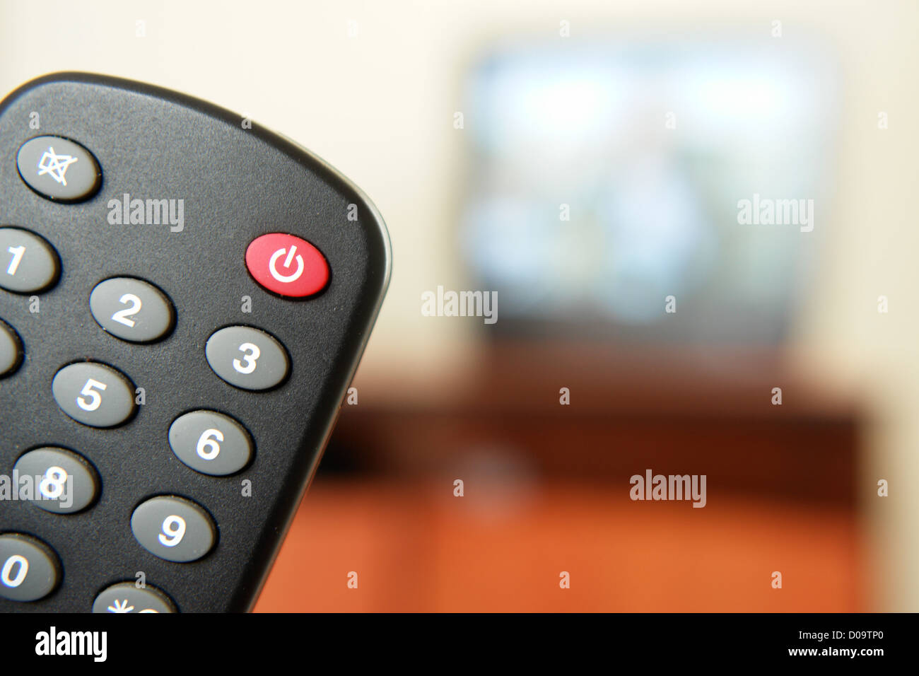 Television screen with tv remote control in foreground Stock Photo - Alamy