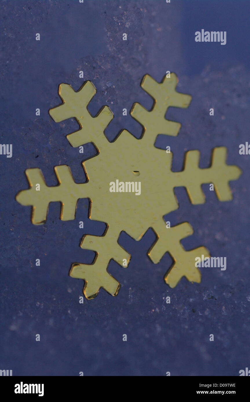 golden snow stars on a real snowy icy surface Stock Photo - Alamy