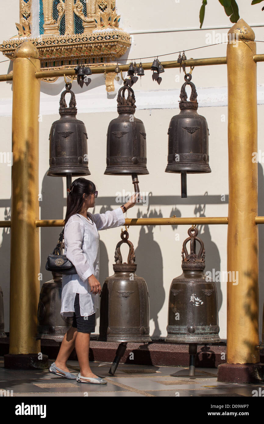 YOUNG THAI WOMAN RINGING THE BELLS OUTSIDE THE WAT PHRA THAT DOI SUTHEP ...