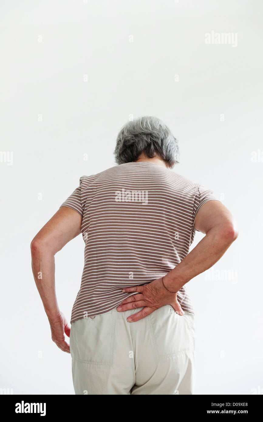 LOWER BACK PAIN IN ELDERLY PERS Stock Photo - Alamy
