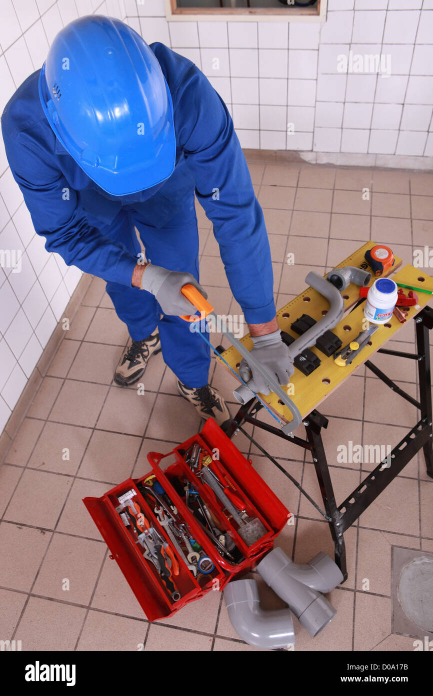 Top-view of plumber cutting pipe Stock Photo - Alamy