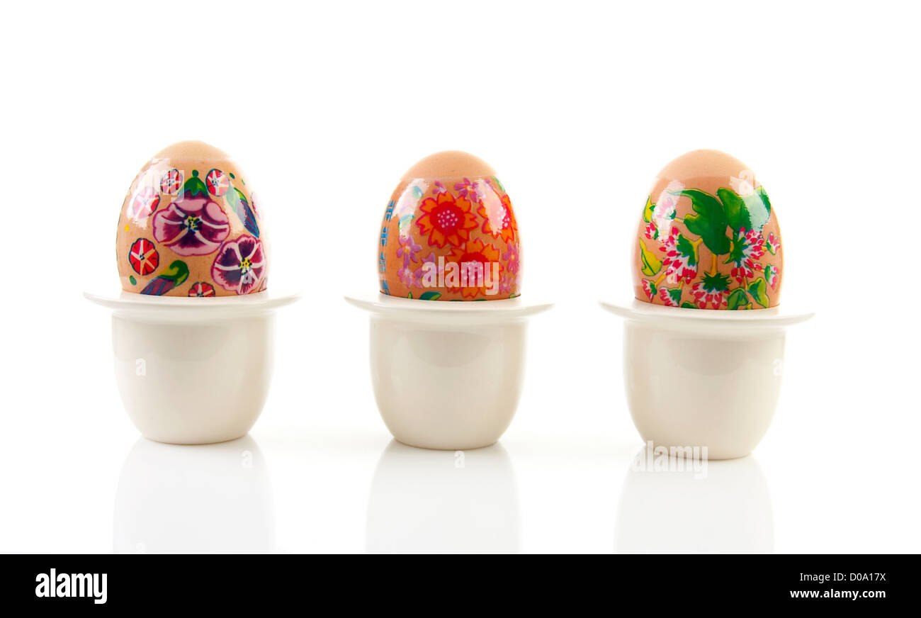 Three decorated chicken eggs in holder over white background Stock ...