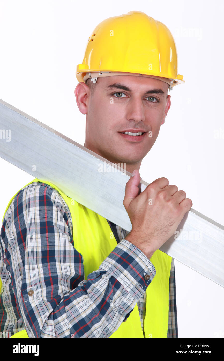 Construction worker carrying metal Stock Photo - Alamy