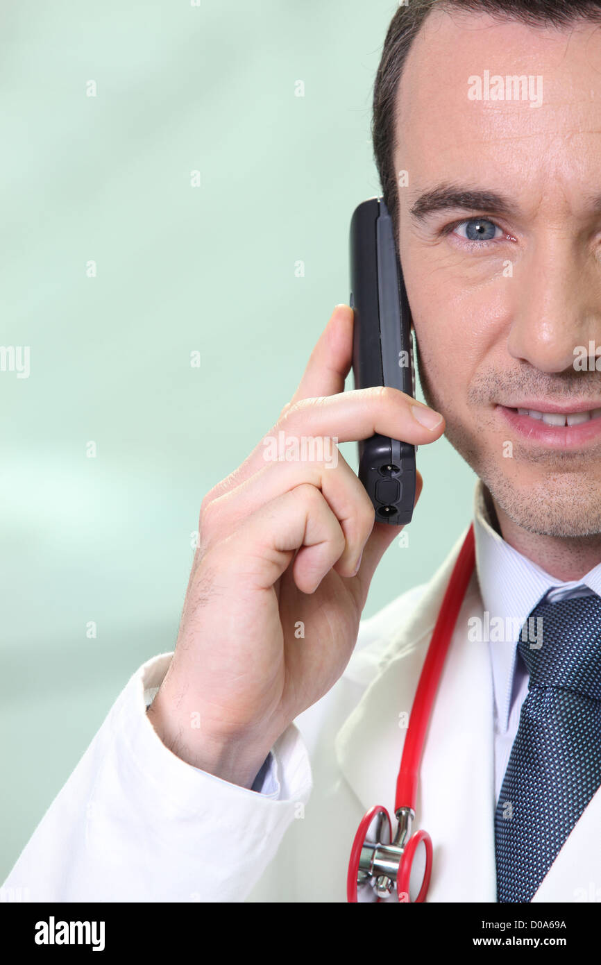Male doctor making telephone call Stock Photo - Alamy