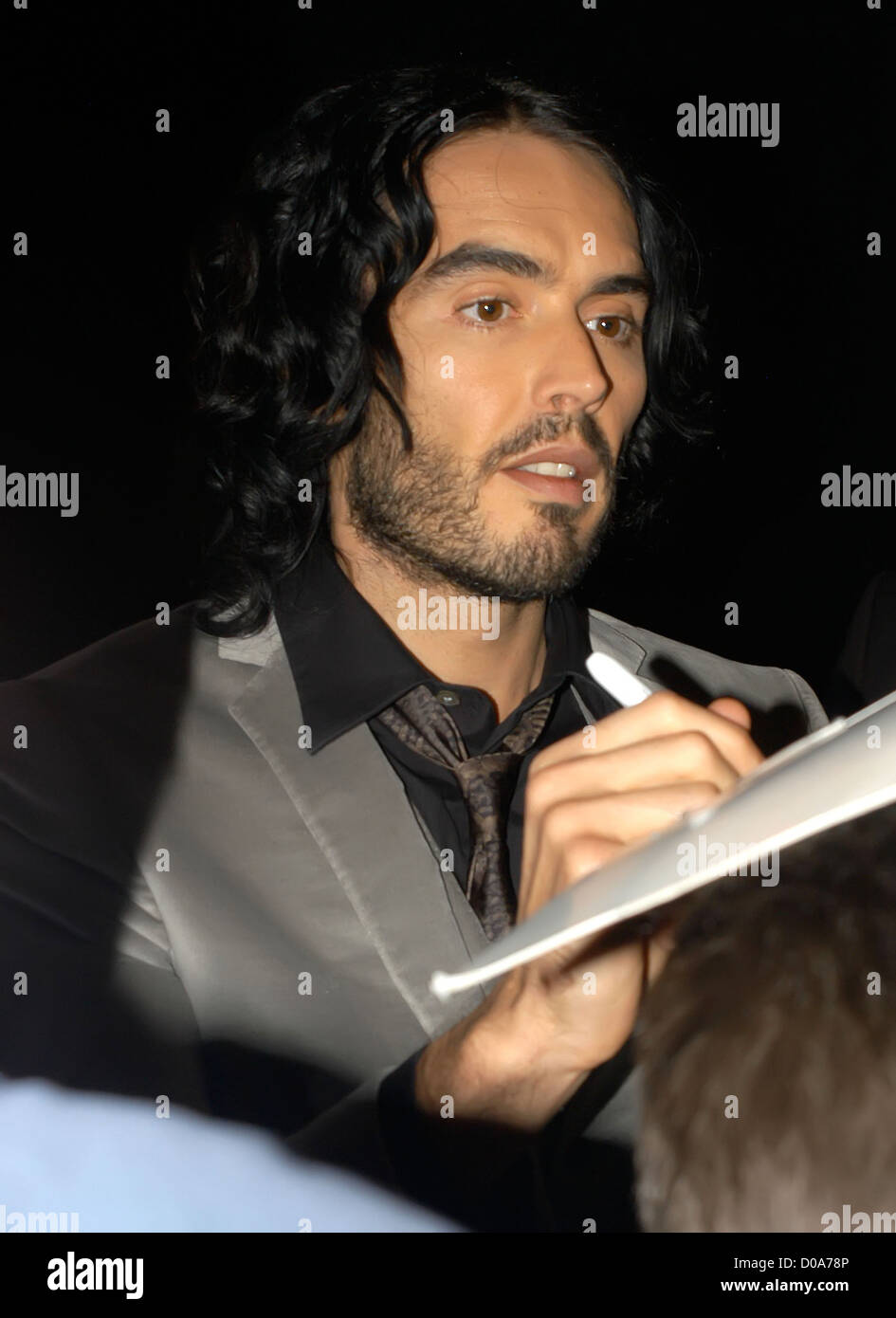 Russell Brand signs autographs for fans at the premiere of 'The Tempest ...