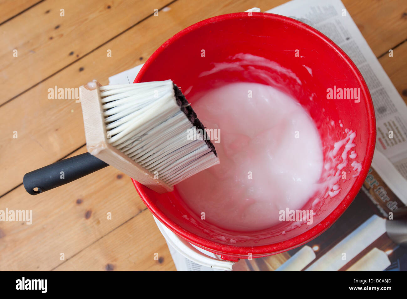 Young wife is renovating her home. Paperhanging, new wallpaper. Do it ...