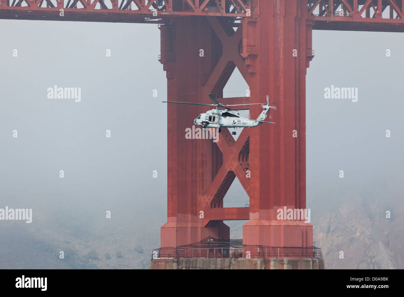 Helicopter from Aircraft carrier USS Carl Vinson passes under the ...