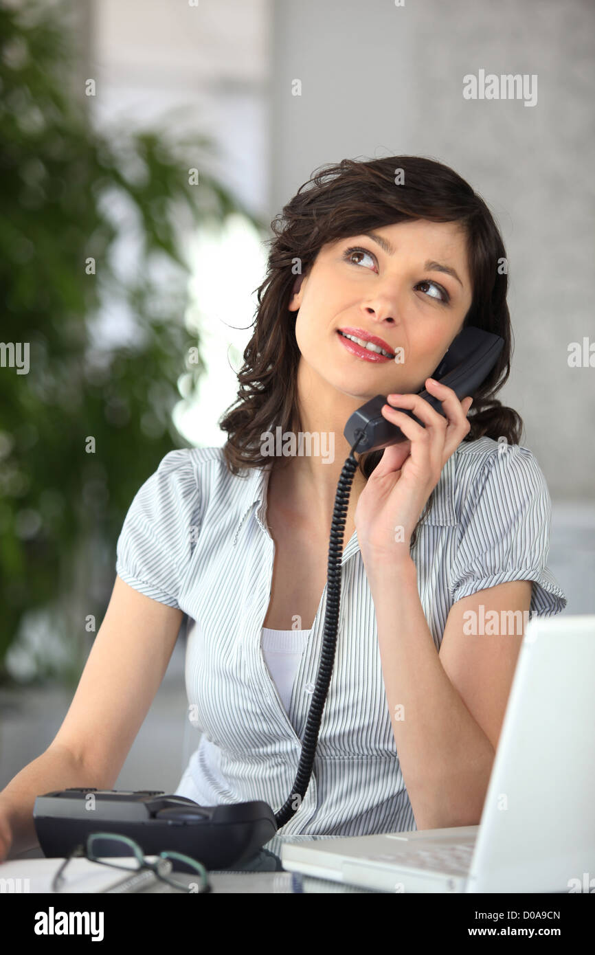 Secretary taking a call Stock Photo - Alamy